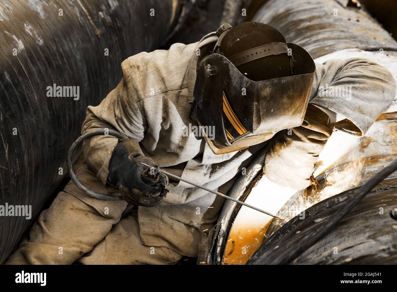 Repair of heating duct. The workers, welders made by electric welding ...