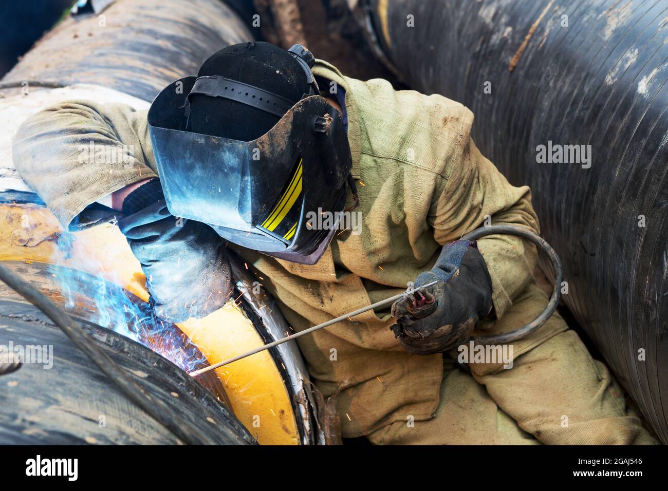 Repair of heating duct. The workers, welders made by electric welding ...