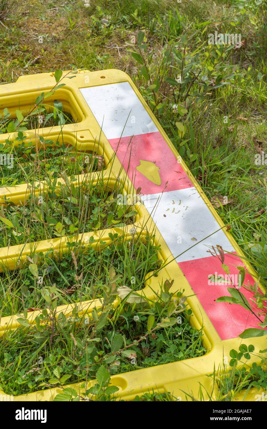 Section of temporary yellow high viz construction site fencing lying on ...