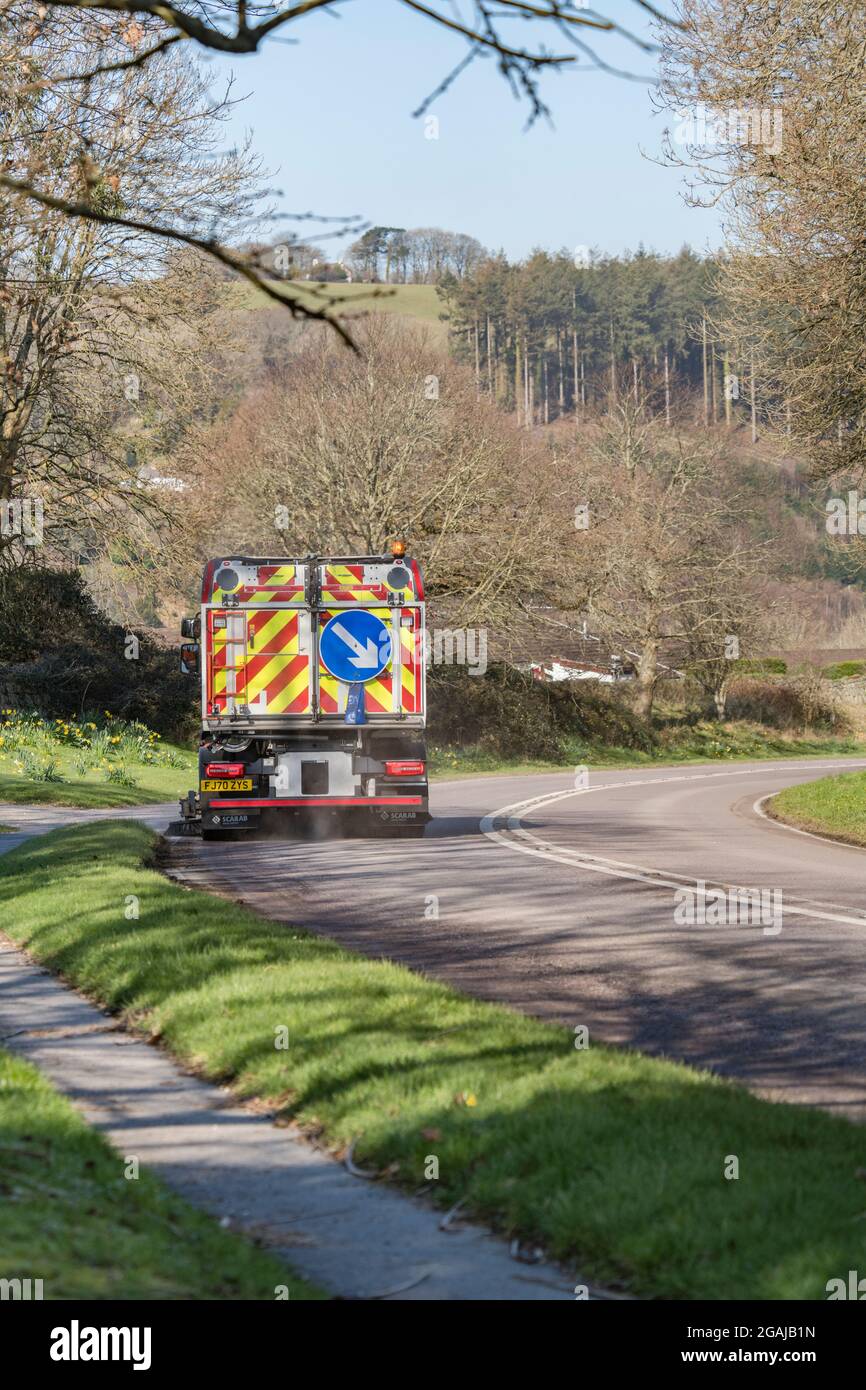 Road sweeping lorry vehicle on the main road running through the ...