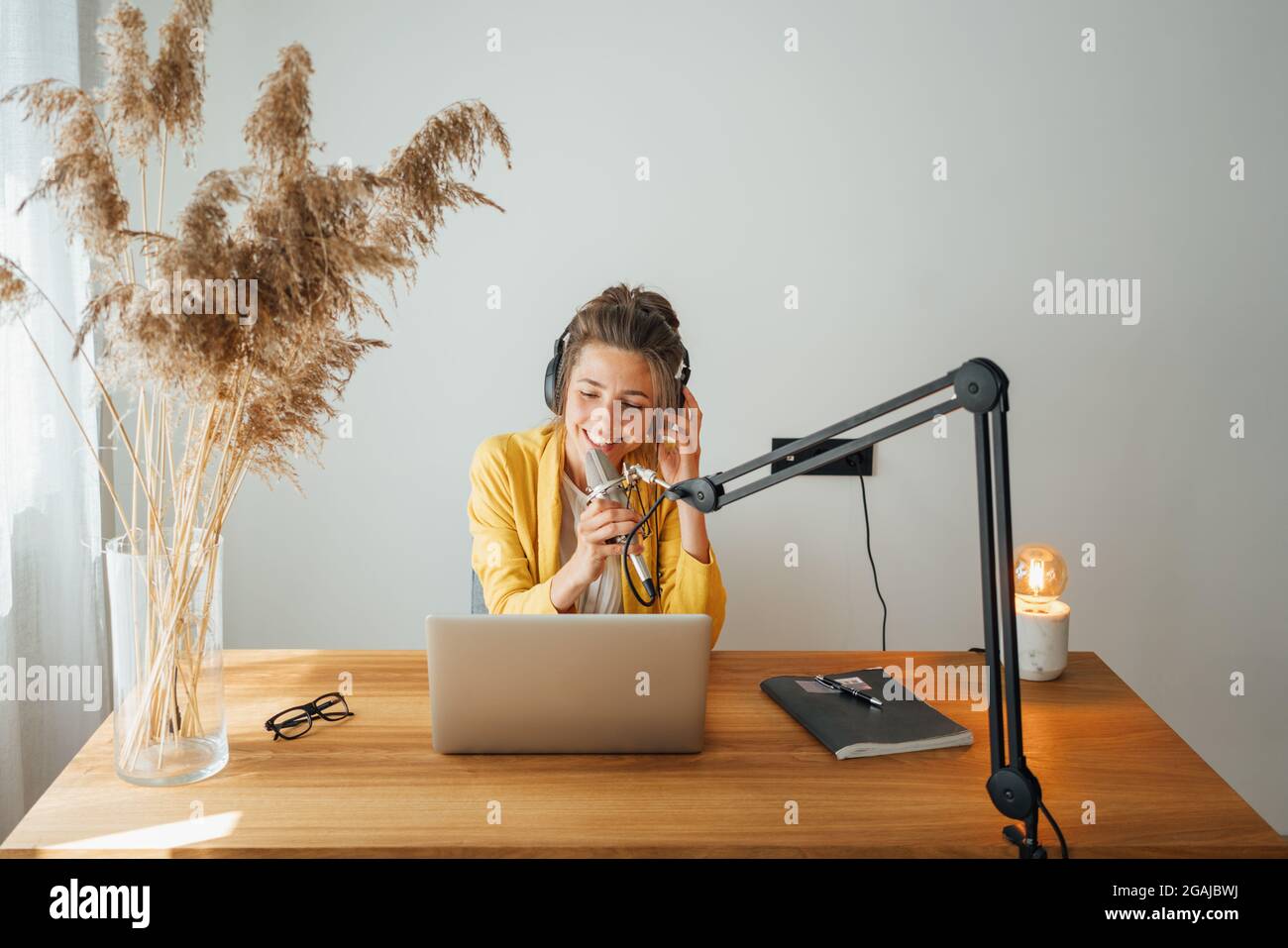 Woman podcaster streaming and broadcasting her podcast from homemade ...