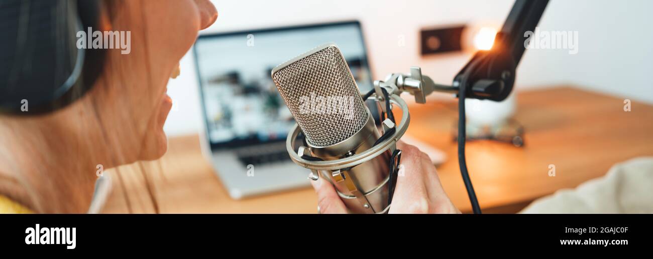 Young female radio host recording and broadcasting her podcast from ...