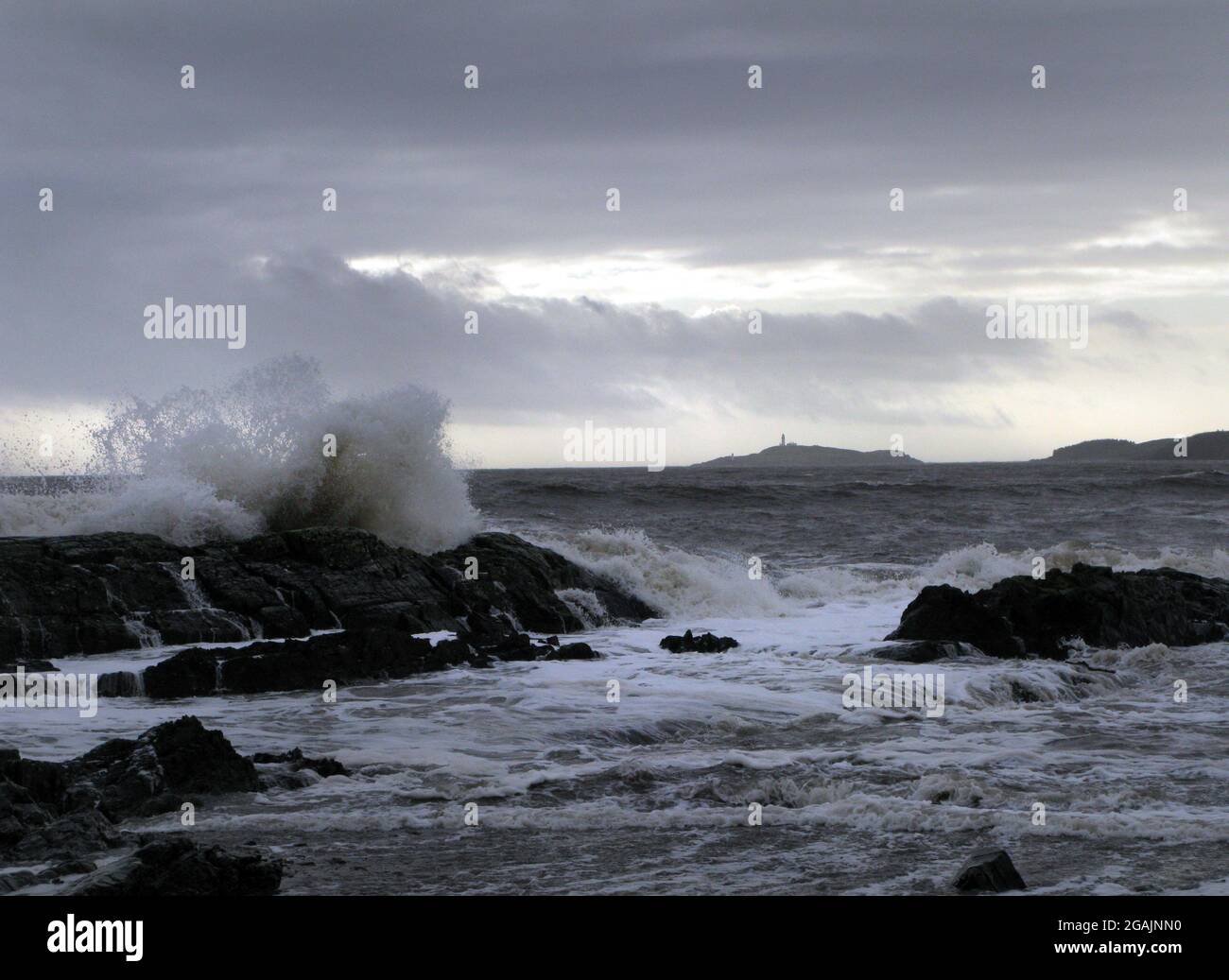Winter storm clouds and gale force wind and waves looking across ...