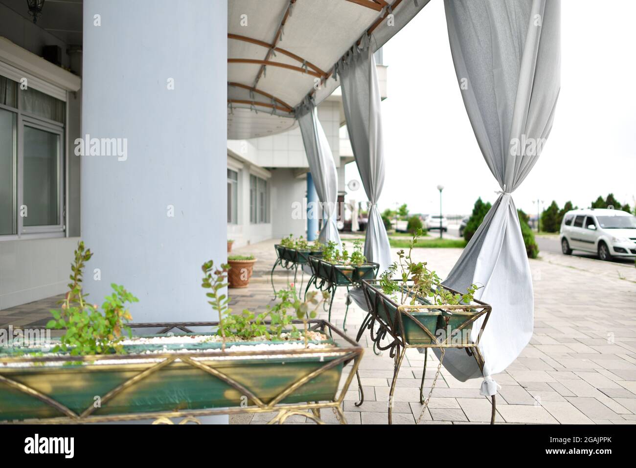 A beautiful wrought-iron flower box encloses the outdoor cafe Stock ...