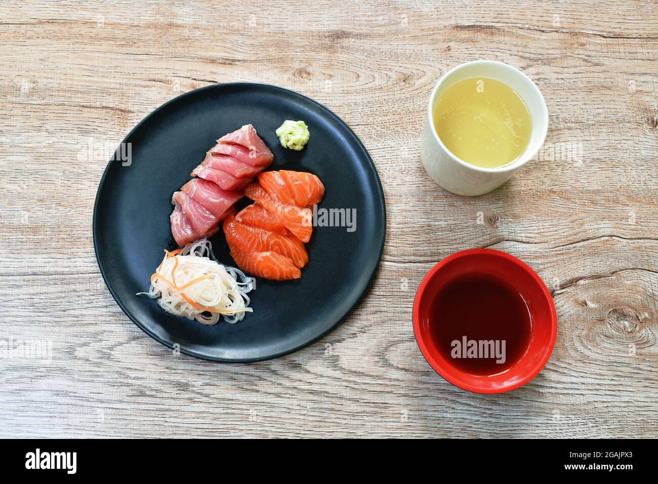 slice raw tuna and salmon fish sashimi Japanese food with radish on ...