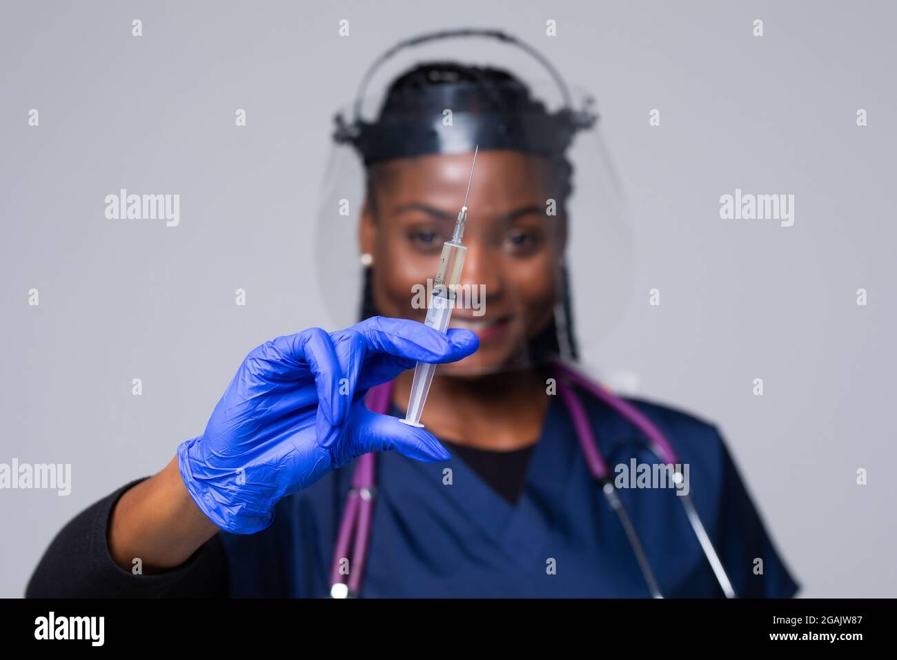 African american doctor holding injection isolated on white background ...