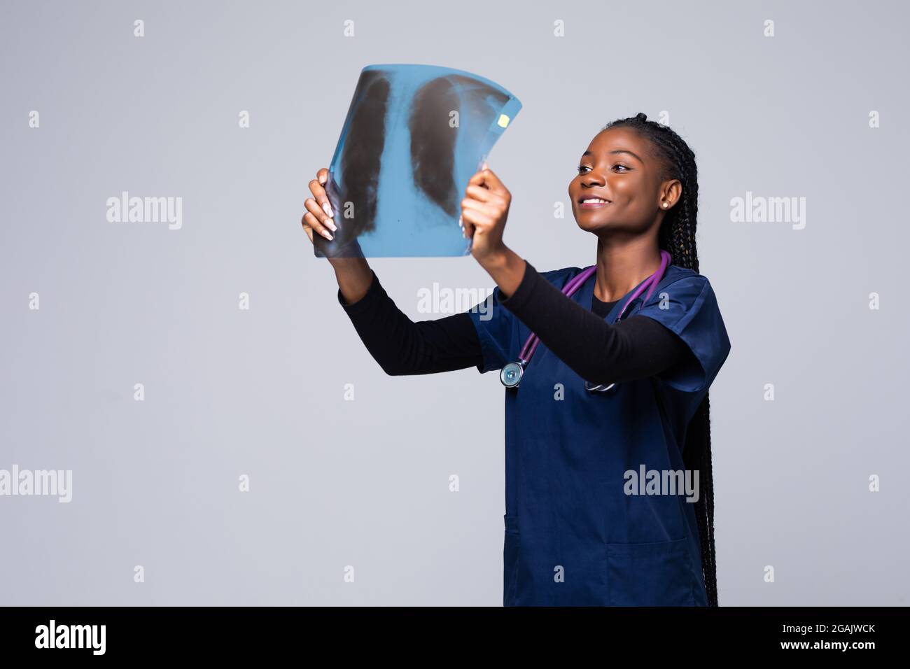 Young African American Nurse Holding A Chest X-Ray isolated on white ...