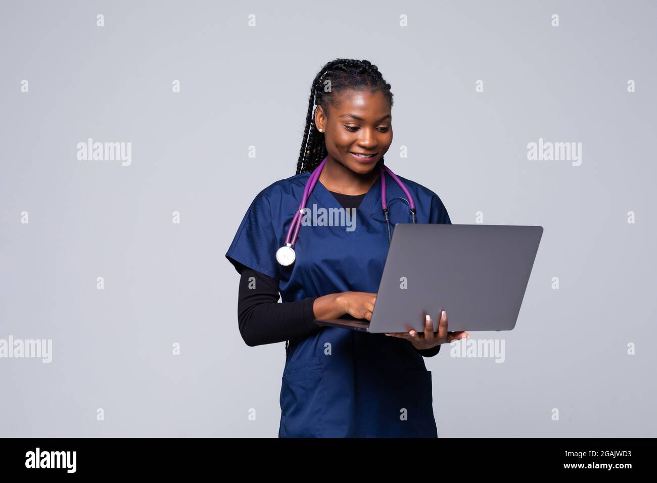 Beautiful African American woman doctor or nurse holding a laptop ...