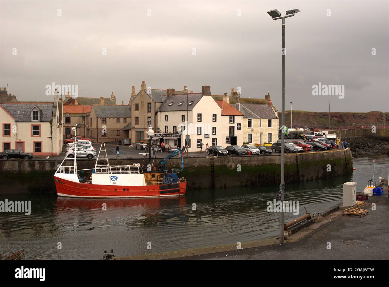Eyemouth harbour fishing boat and town on dull day Stock Photo - Alamy