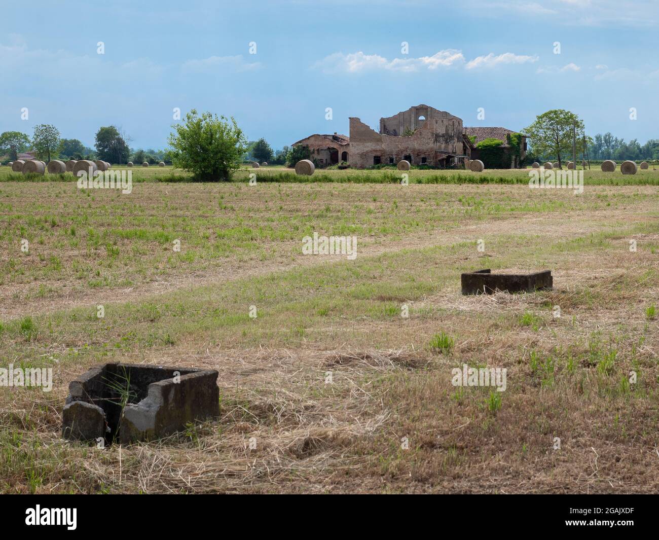 Bales of Hay in the Countryside and a Ruined Farmhouse Stock Photo - Alamy