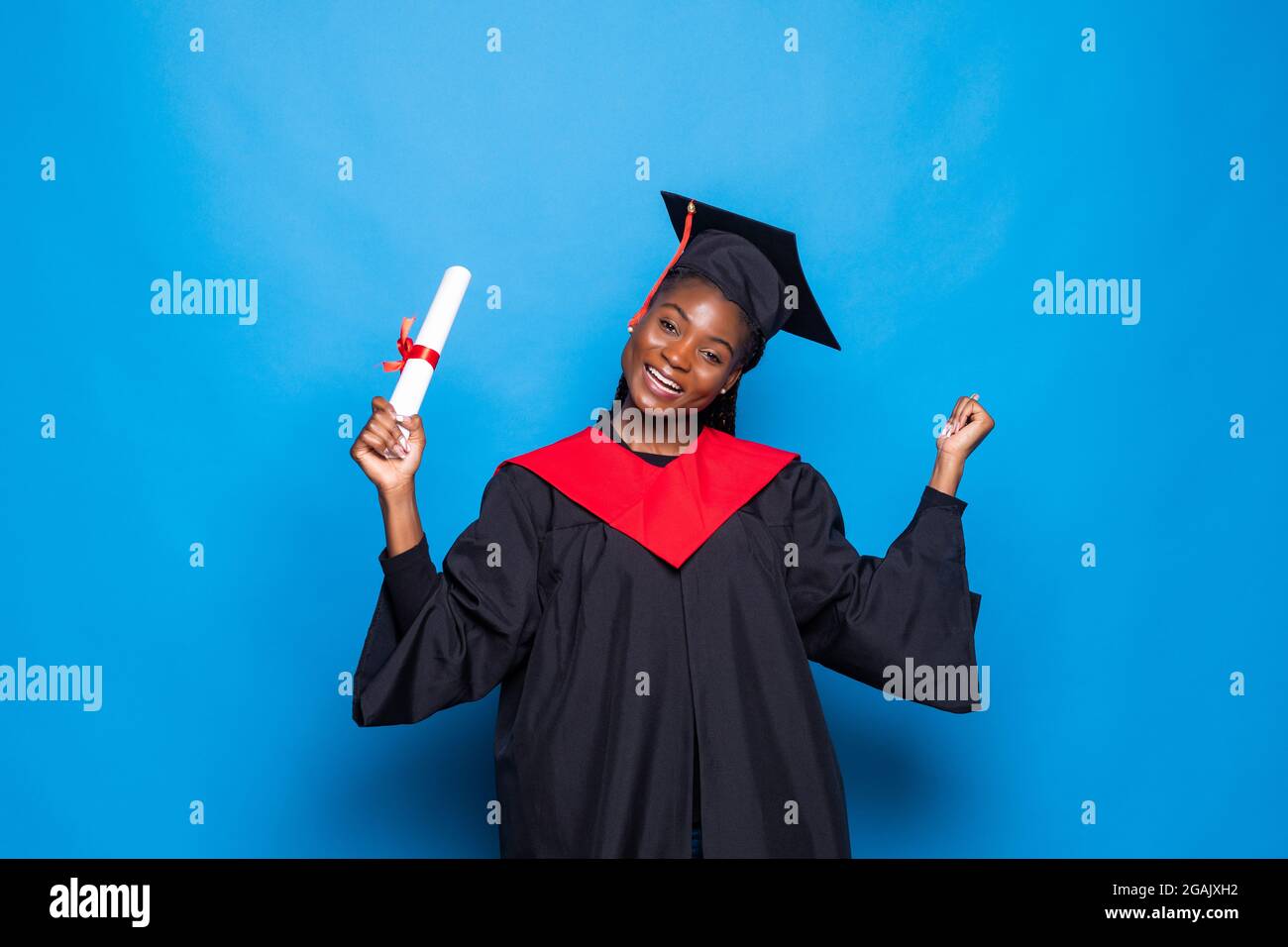 Happy african student with graduation hat and diploma isolated on blue ...