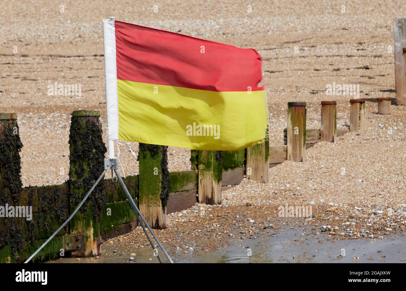 RNLI red and yellow rescue flag seen on the beach Stock Photo - Alamy
