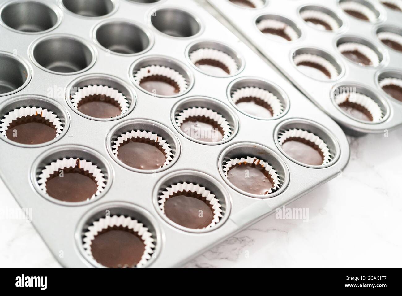 Baking chocolate mini cupcakes in cupcake pan Stock Photo - Alamy