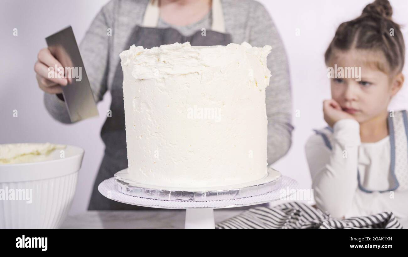 Step by step. Frosting round funfetti cake with white italian ...