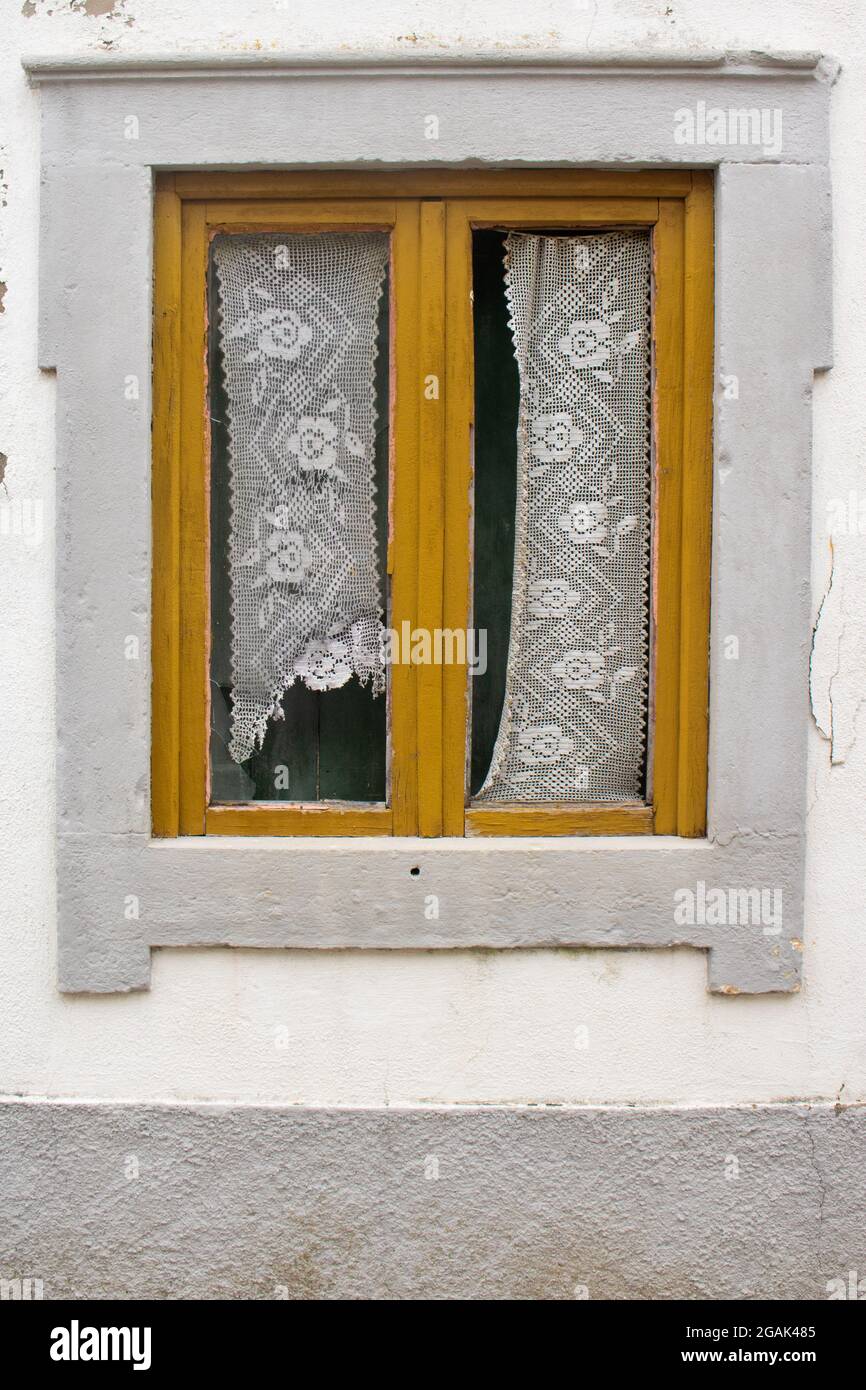 Detail of broken window in abandoned rural house with yellow wooden ...
