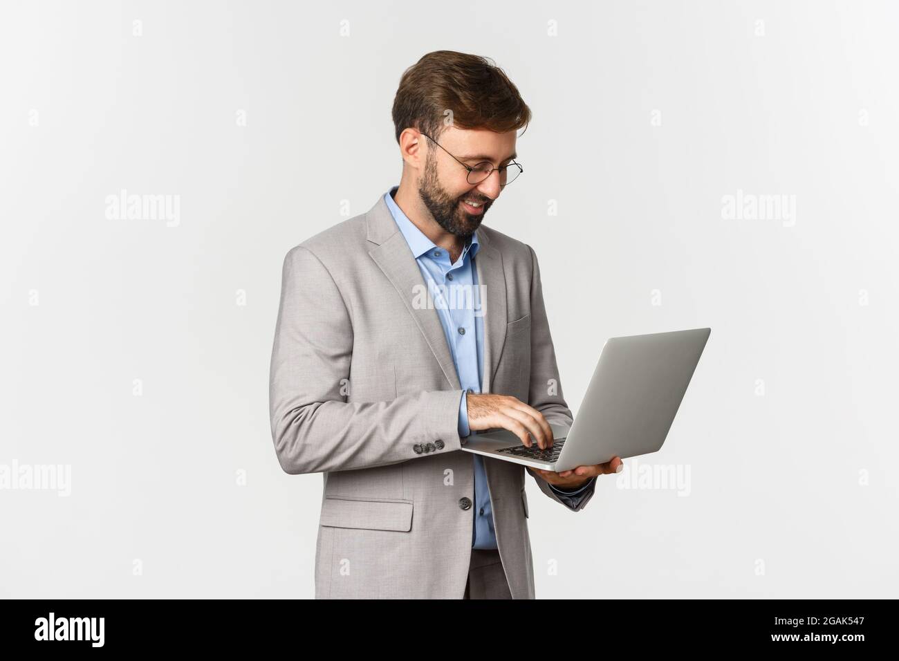 Image of handsome successful businessman working, standing in grey suit ...