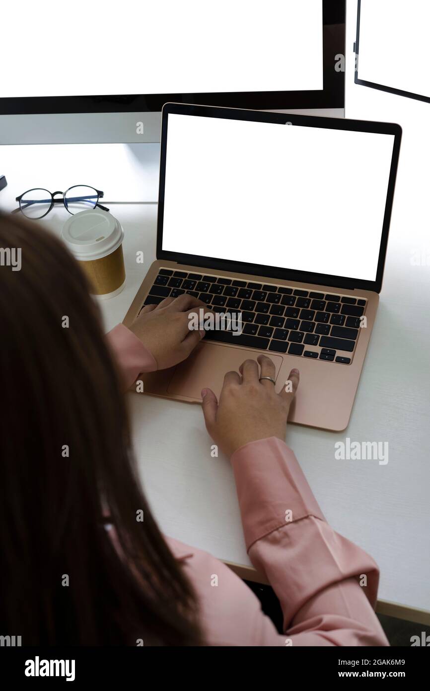 Back view of businesswoman siting at office desk and working with ...