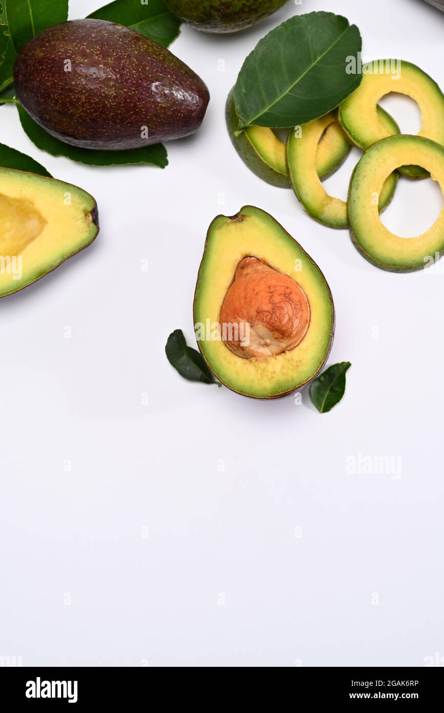 Half and sliced avocado isolated on white background. Healthy fruits ...