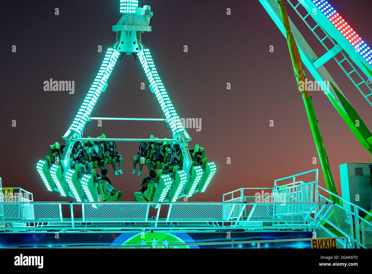 ferris wheel and attraction close-up in flight Stock Photo - Alamy