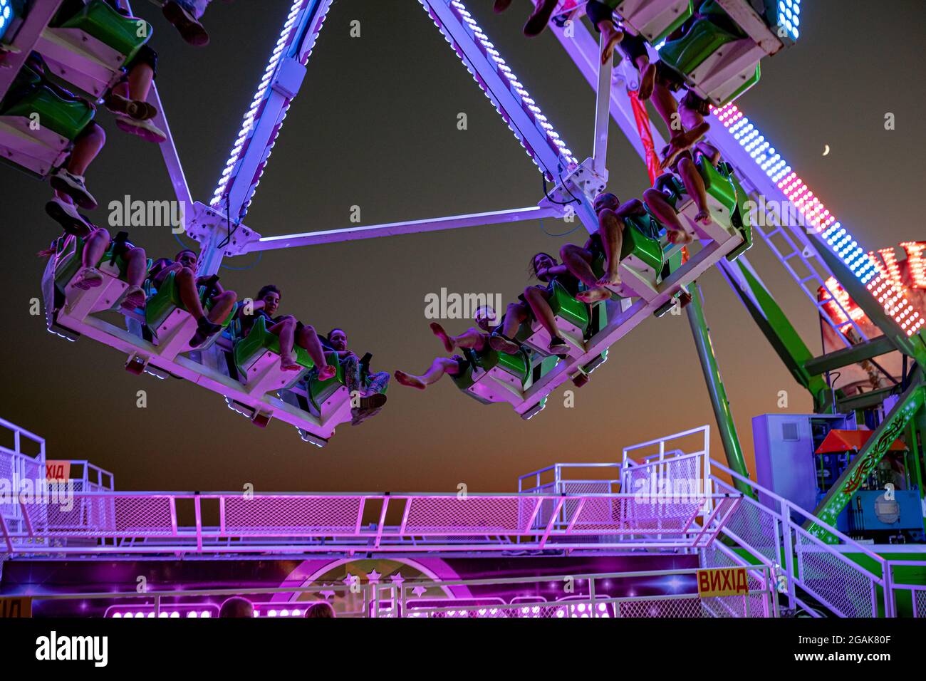ferris wheel and attraction close-up in flight Stock Photo - Alamy