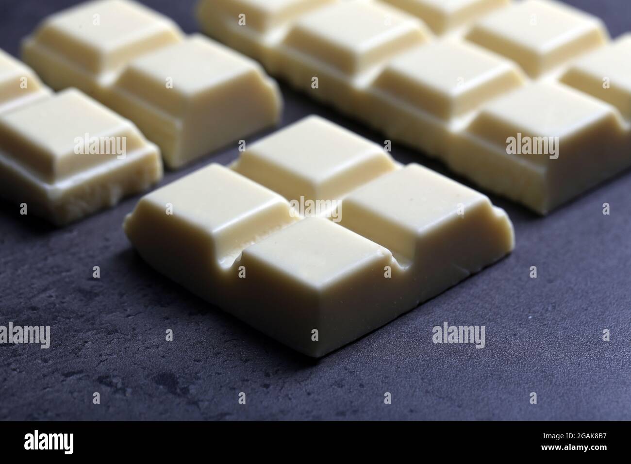 White chocolate pieces on gray background Stock Photo - Alamy