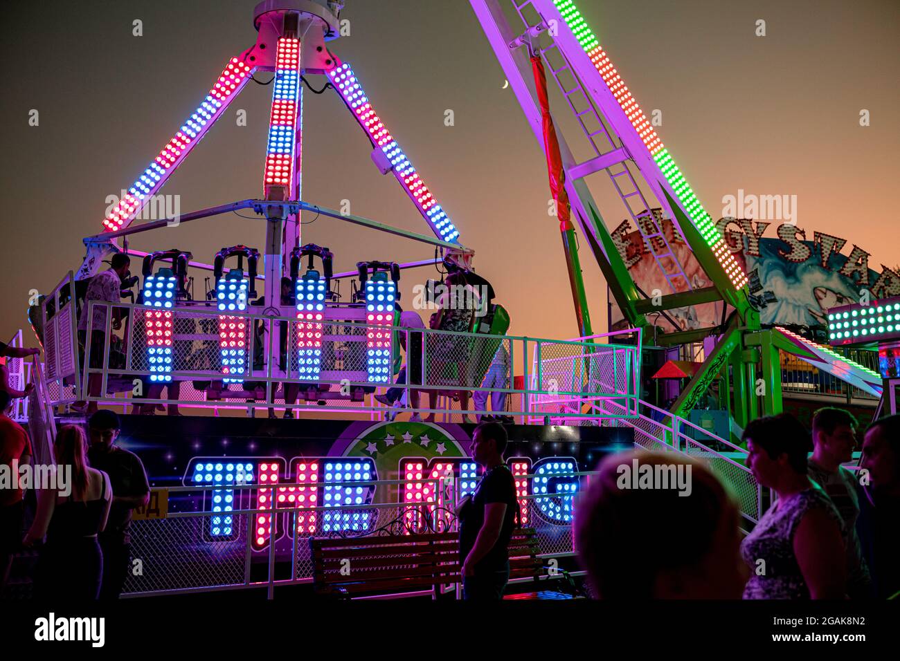 ferris wheel and attraction close-up in flight Stock Photo - Alamy