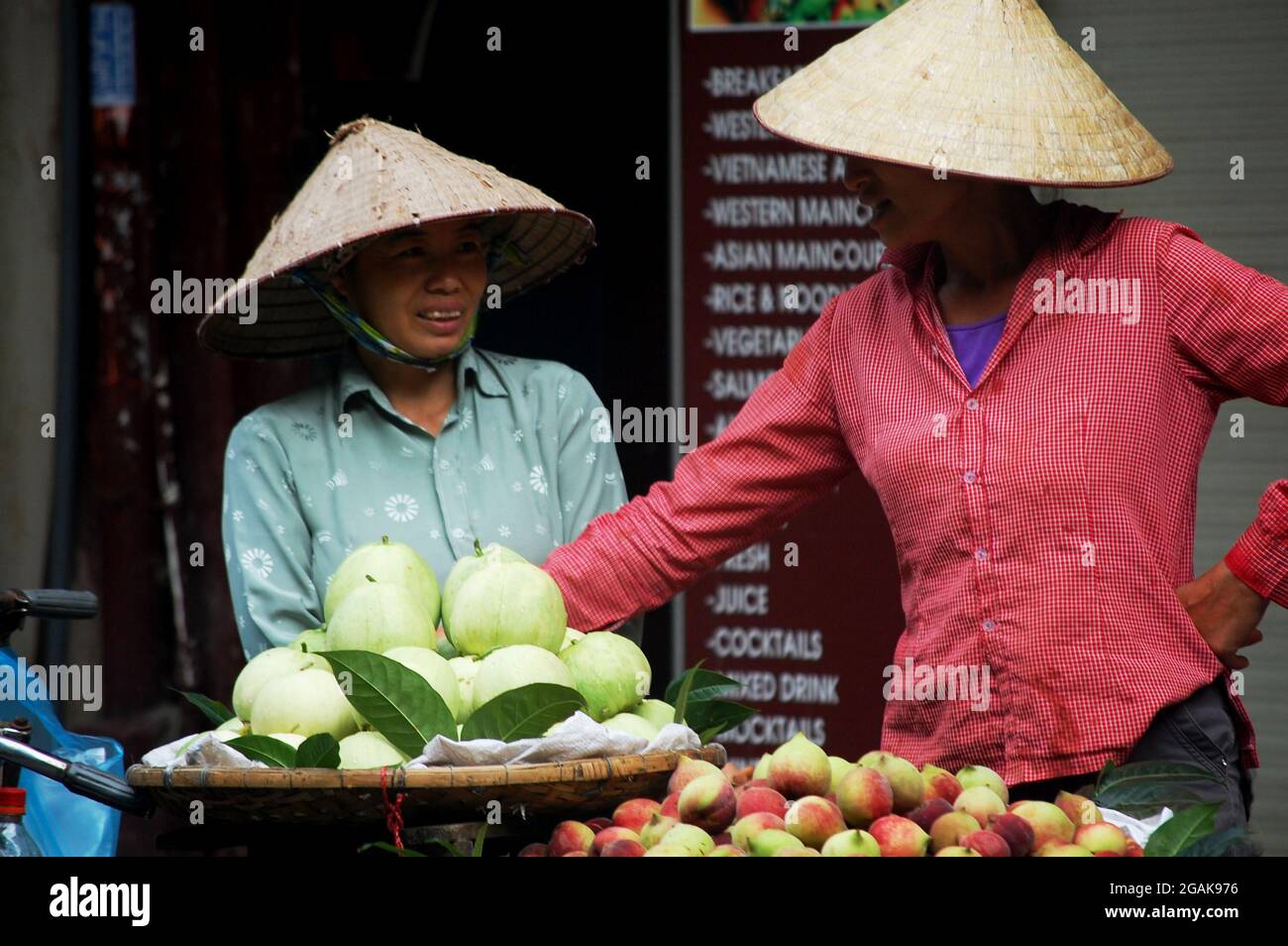 Vietnam woman people push bicycle cart hawker on road sale guava fruits ...
