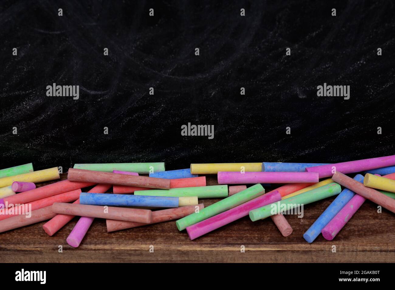 Many chalks on desk background Stock Photo - Alamy