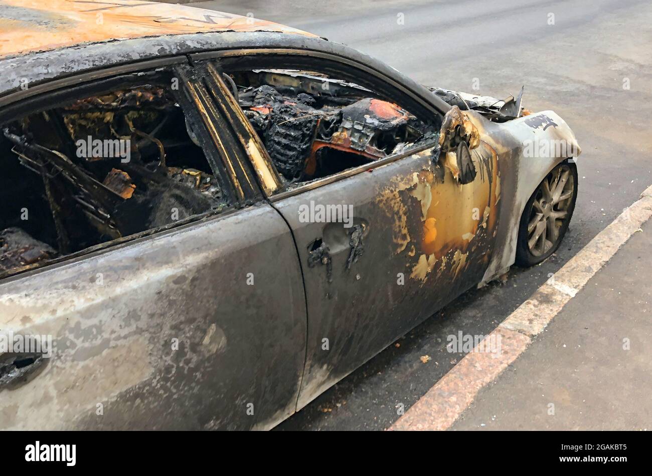 Burned-out car on the side of the road Stock Photo - Alamy