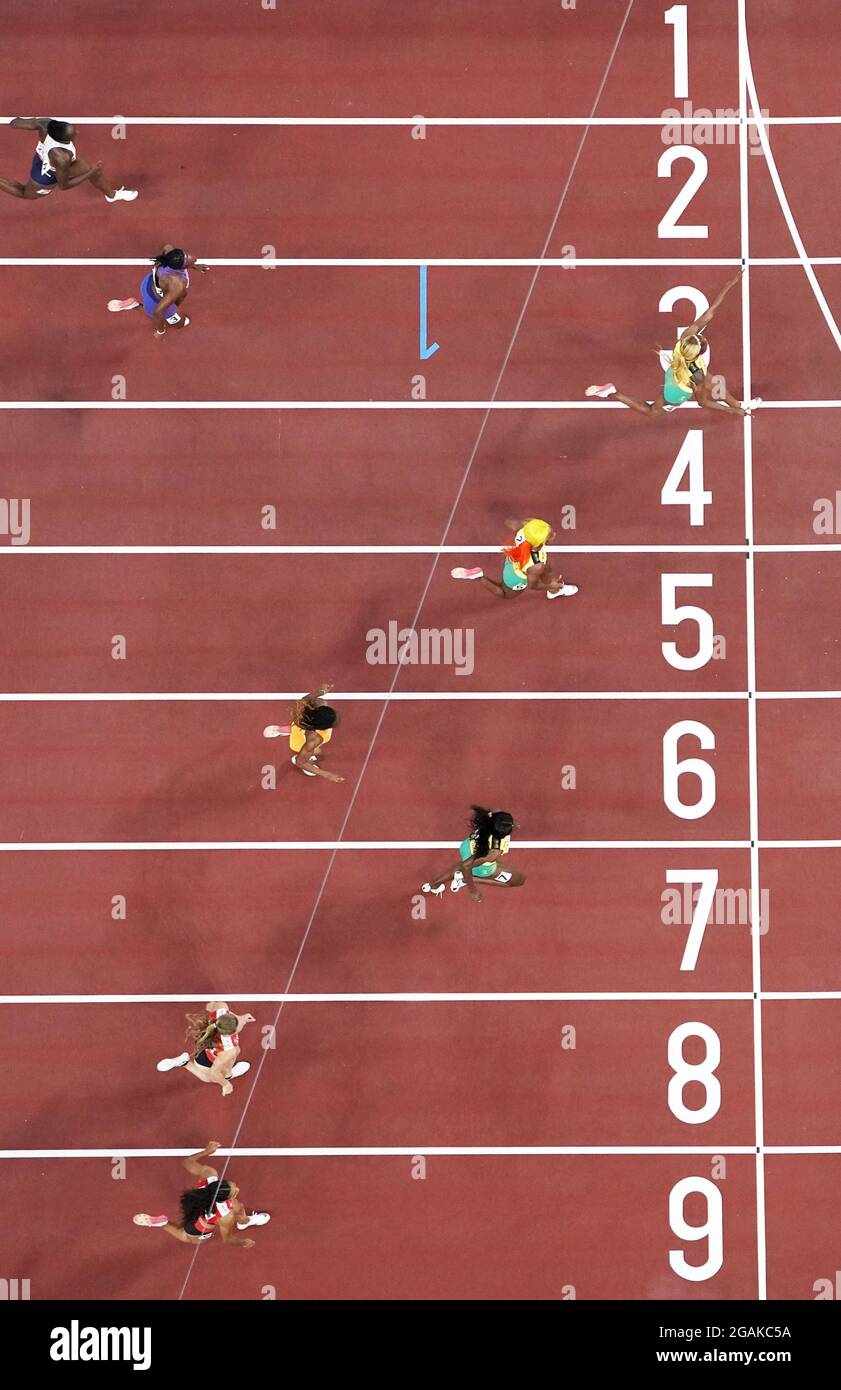 Jamaica's Elaine Thompson-Herah (Lane 4) crosses the finish line to win ...