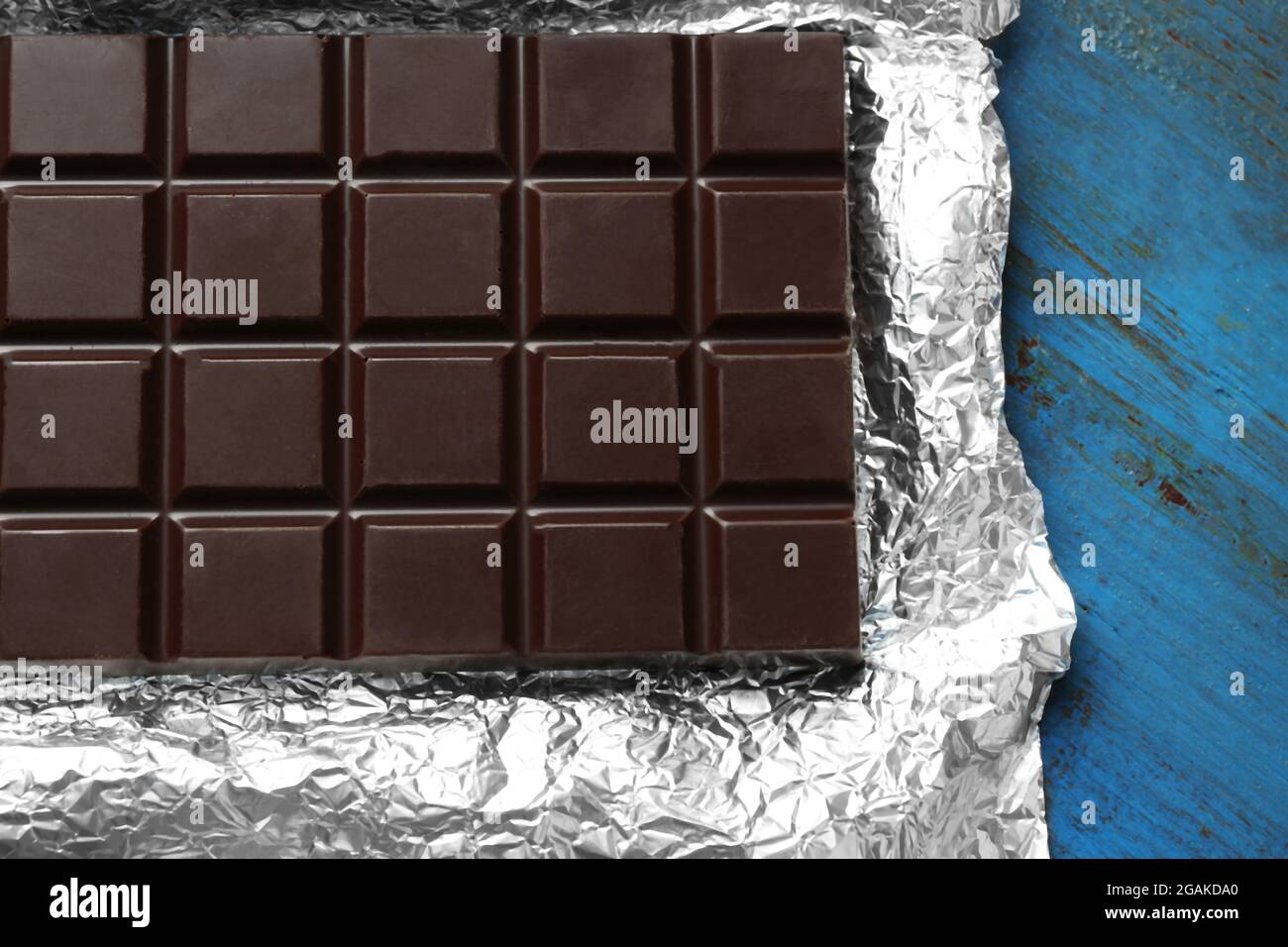 Dark Chocolate bar in foil on gray background Stock Photo - Alamy