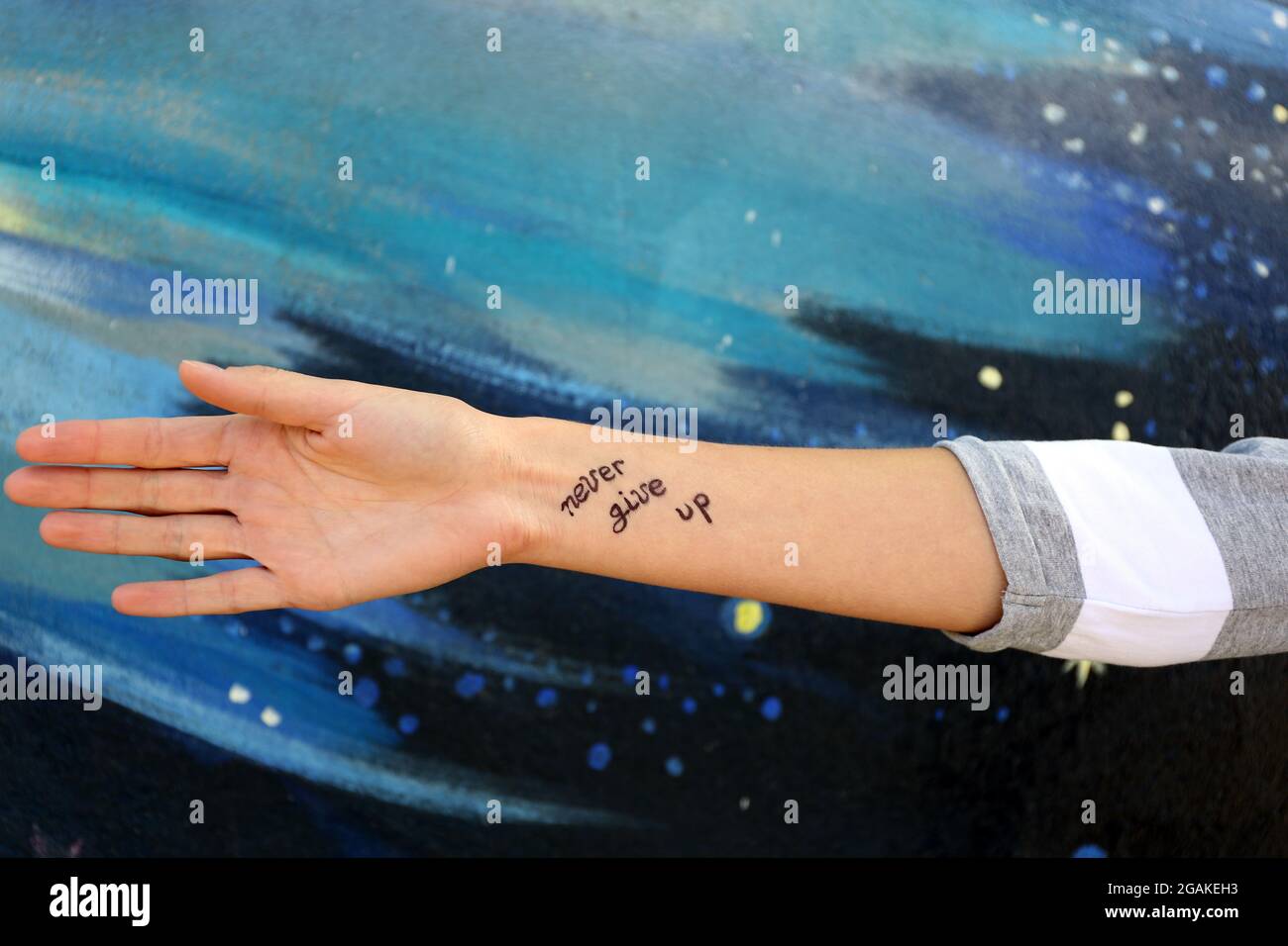 Female hand with tattoo on wall background Stock Photo - Alamy