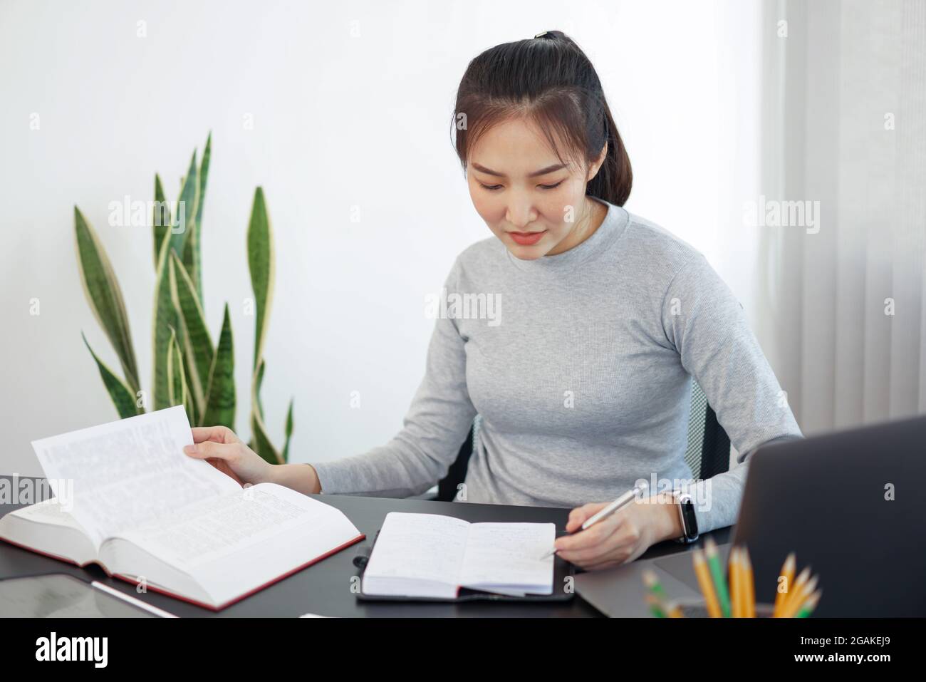 Office work concept a female secretary writing some information into a ...