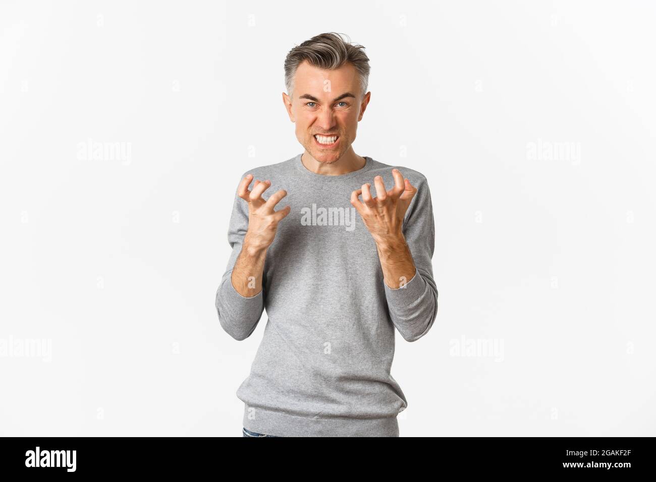 Image of angry middle-aged man cursing someone, looking mad and ...