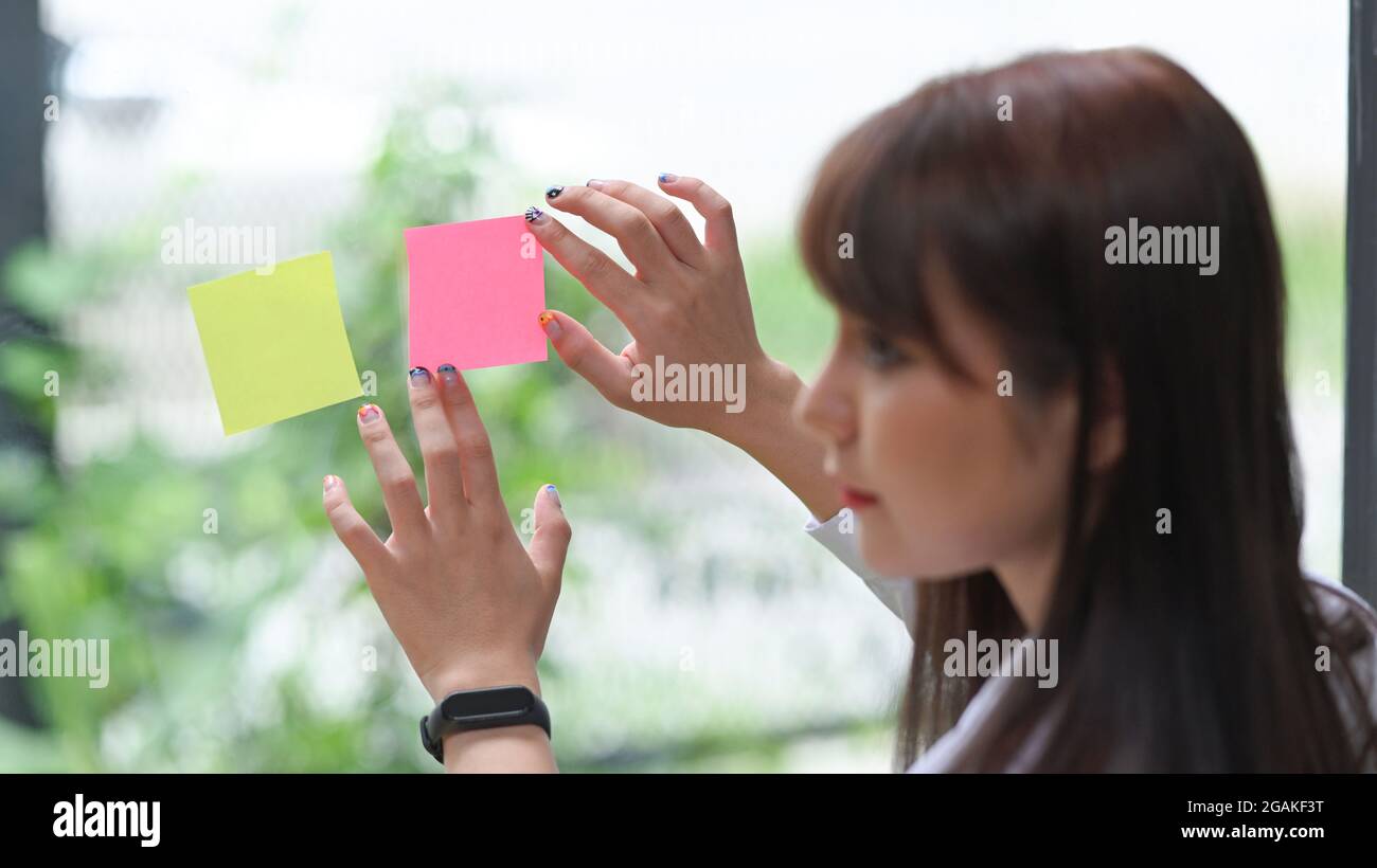Woman putting sticky notes on hi-res stock photography and images - Alamy