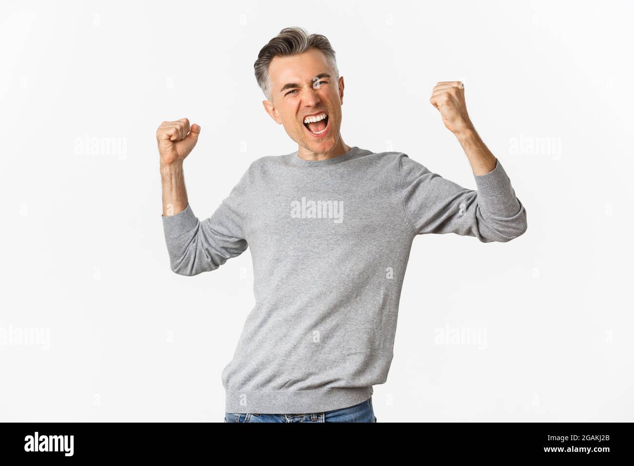 Image of successful middle-aged man triumphing, shouting for joy ...