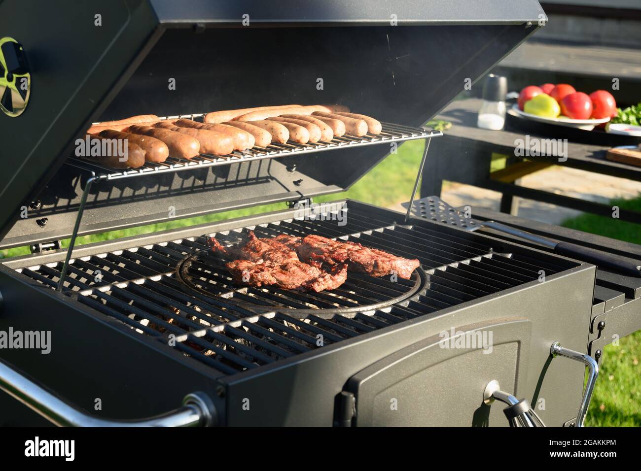 Grilled beef meat and sausages outside. BBQ grill. Barbecue party ...