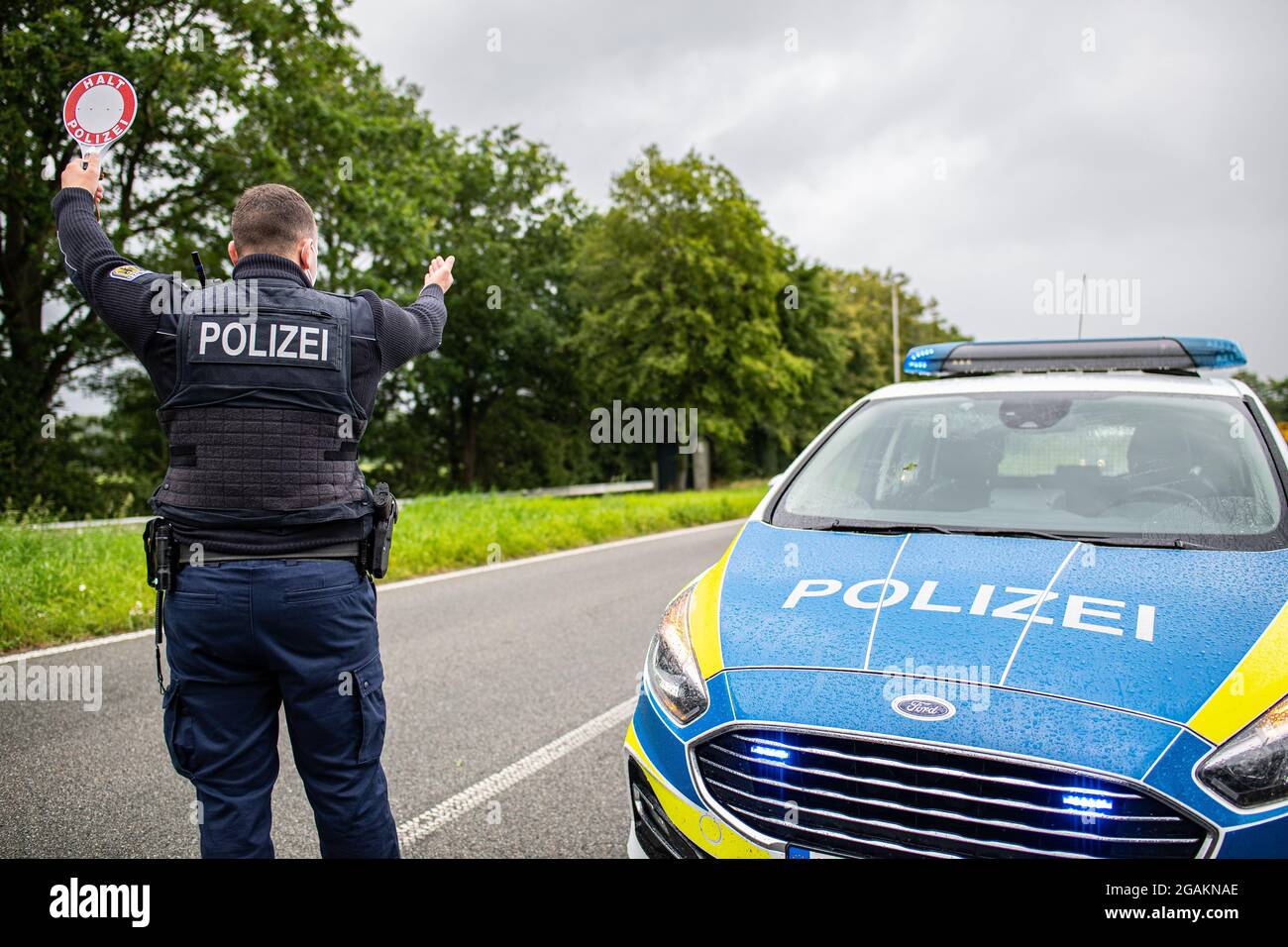 Emmerich, Germany. 31st July, 2021. A police officer stands with a ...
