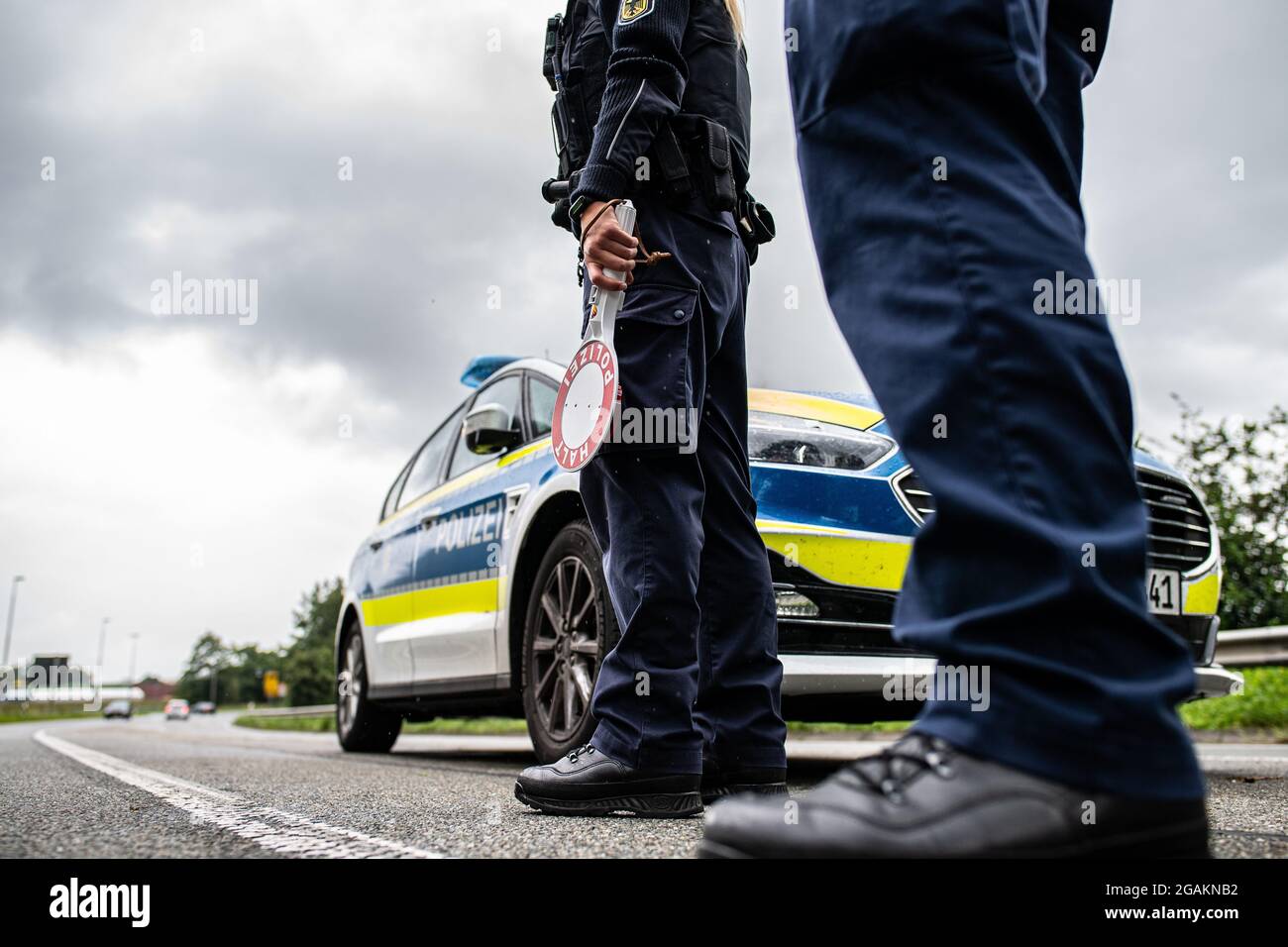 Emmerich, Germany. 31st July, 2021. Police officers stand with a police ...