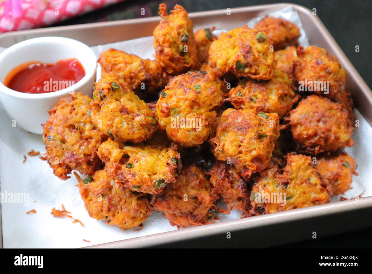 Indian vegetable snack with red chutney Stock Photo - Alamy