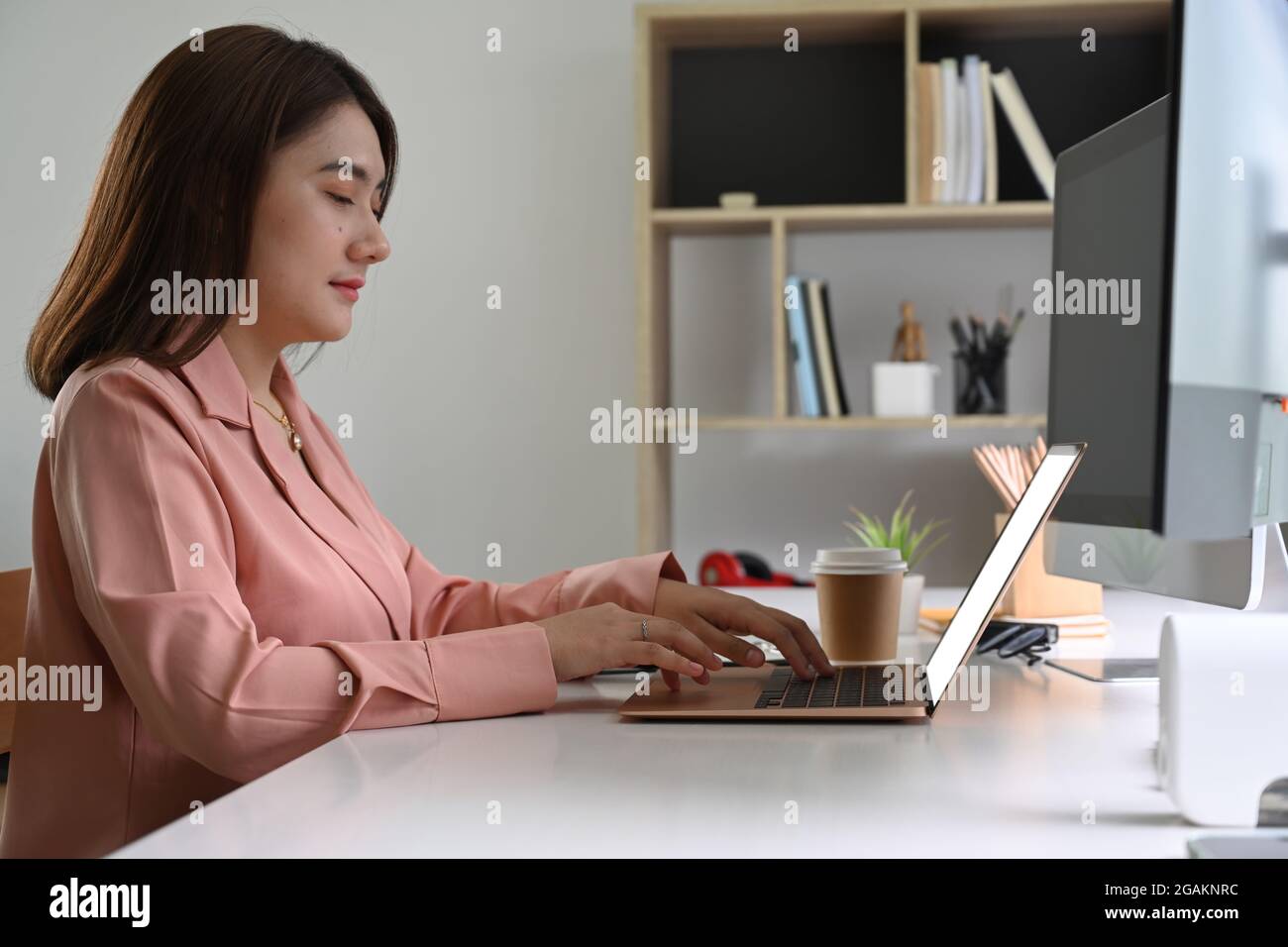 Side view young female working with computer laptop at home Stock Photo ...
