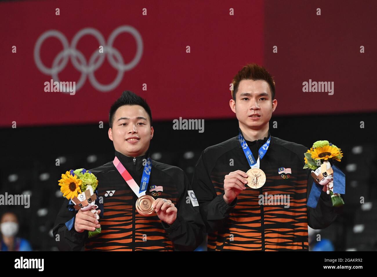 Tokyo, Japan. 31st July, 2021. Malaysia's Aaron Chia (L) /Soh Wooi Yik pose for photos with ...