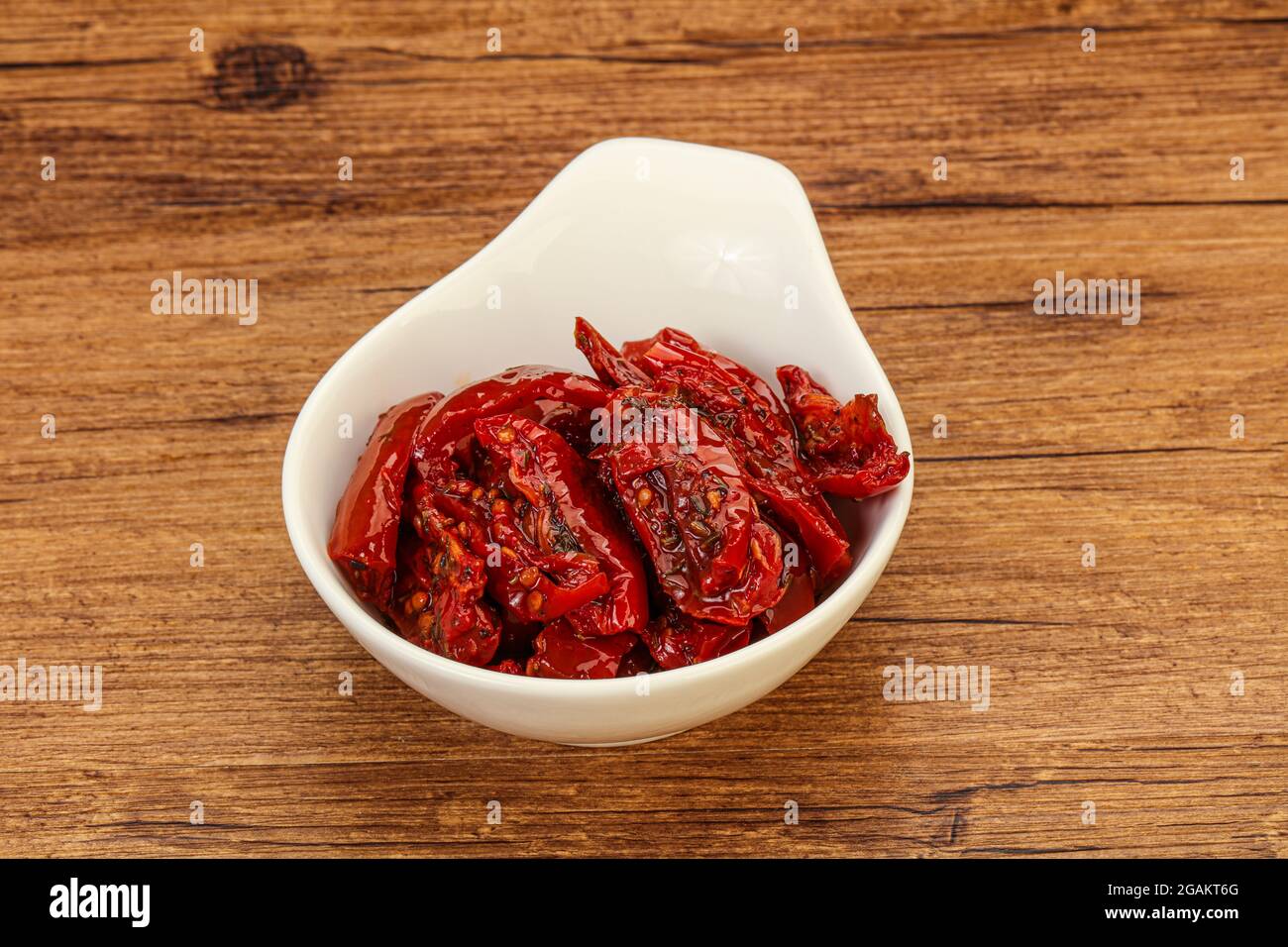 Dried tomato with olive oil and herbs Stock Photo - Alamy
