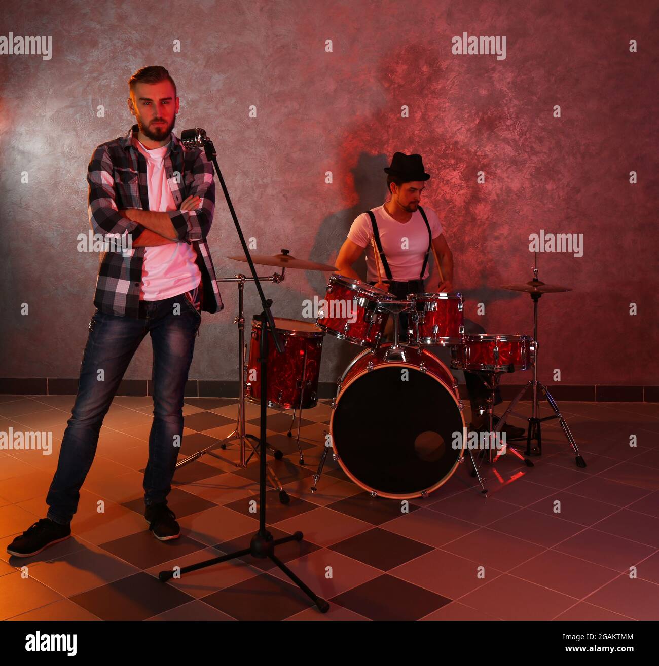 Musicians playing musical instruments and singing songs in a studio ...