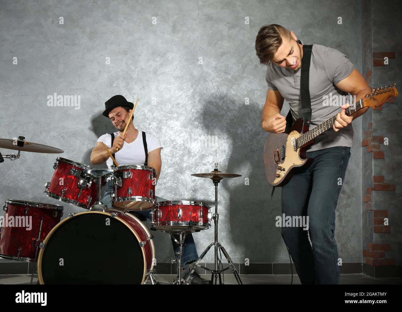 Musicians playing musical instruments and singing songs in a studio ...