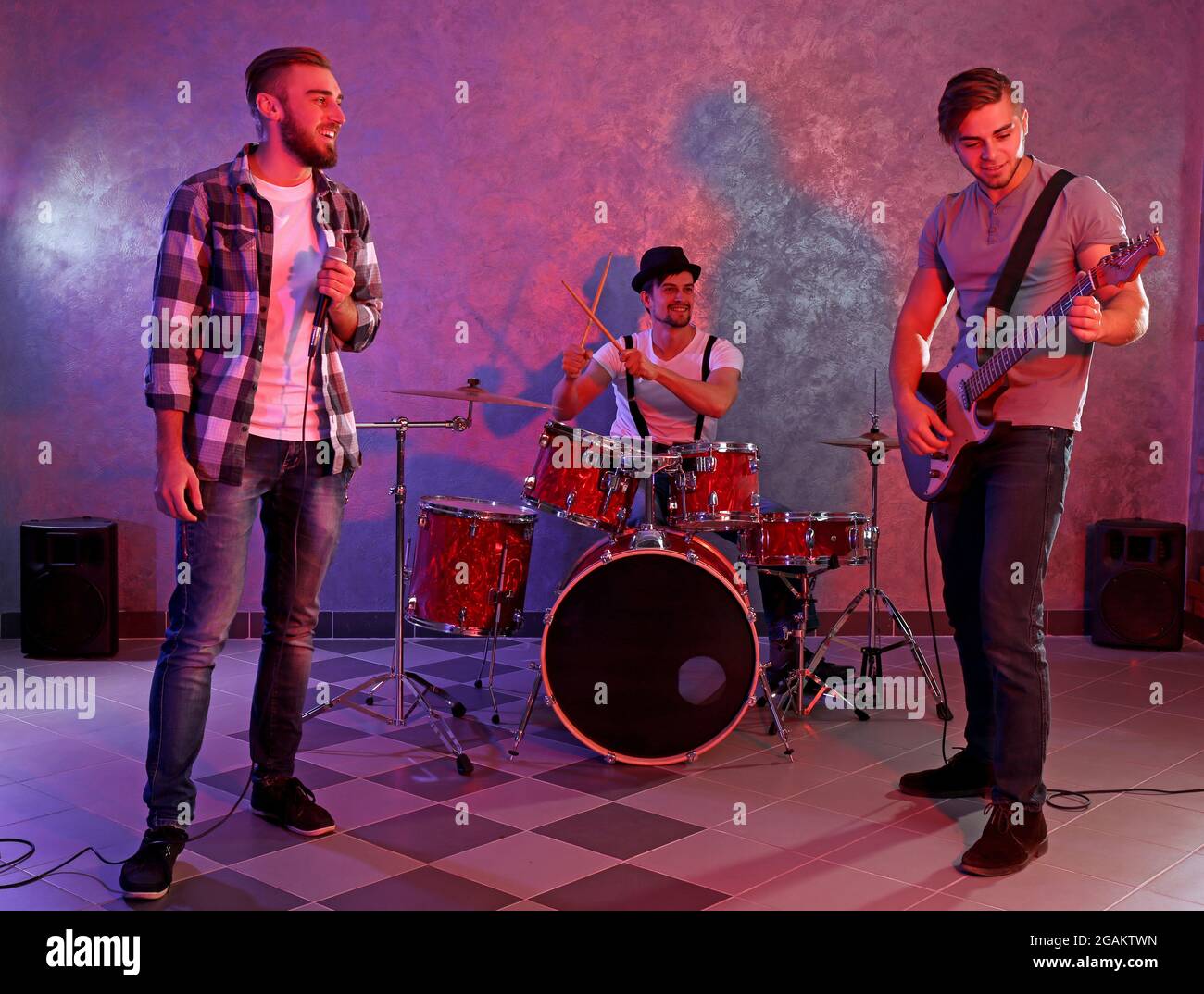 Musicians playing musical instruments and singing songs in a studio ...