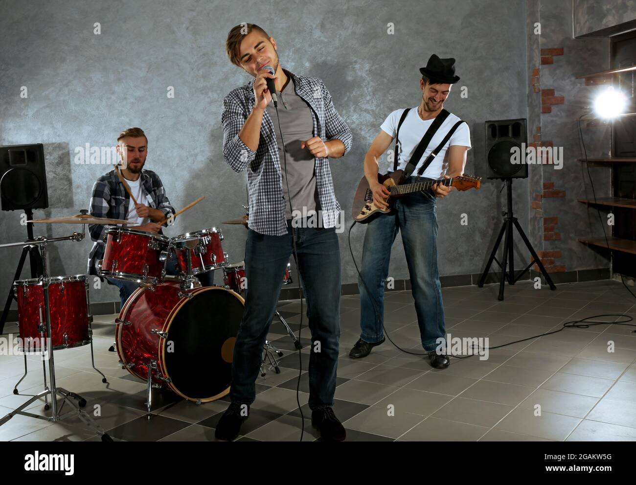 Musicians playing musical instruments and singing songs in a studio ...