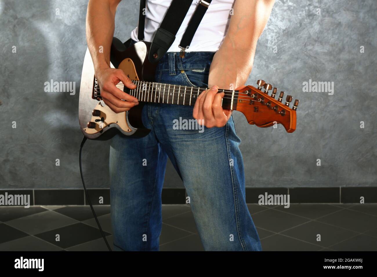 Young man paying guitar closeup Stock Photo - Alamy