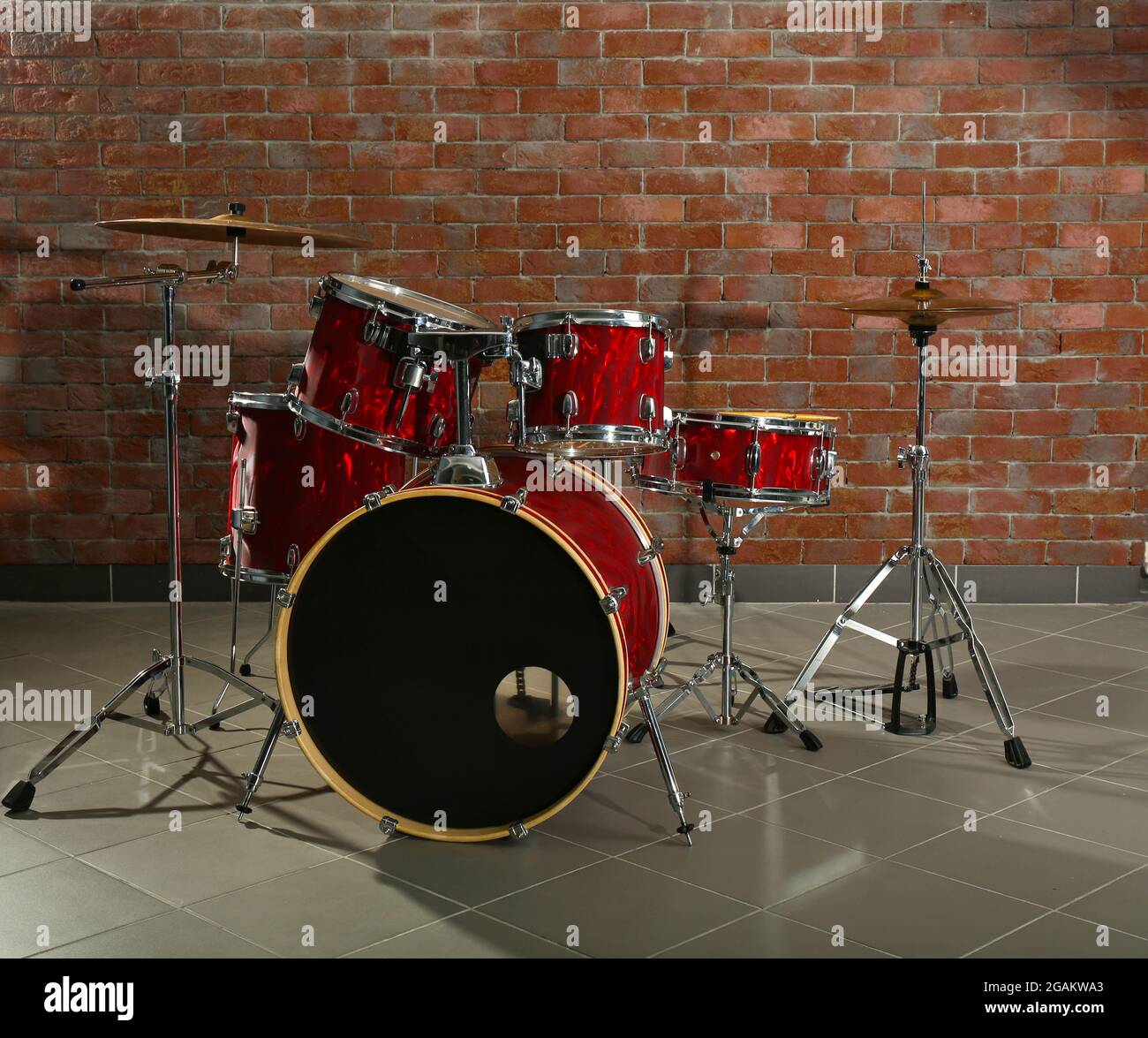 Drum set on brick wall background Stock Photo - Alamy