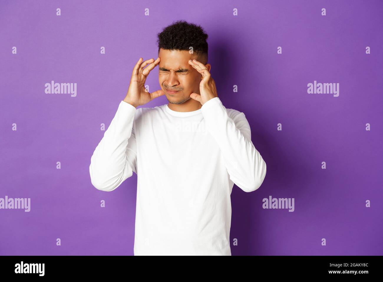 Image of handsome african-american man having headache, grimacing and ...
